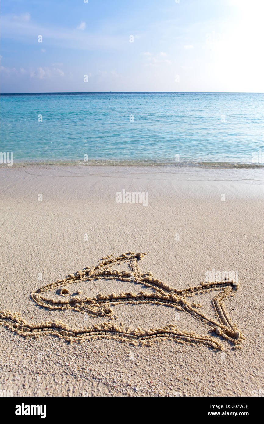 Drawing on sand on a theme of rest - fish Stock Photo - Alamy