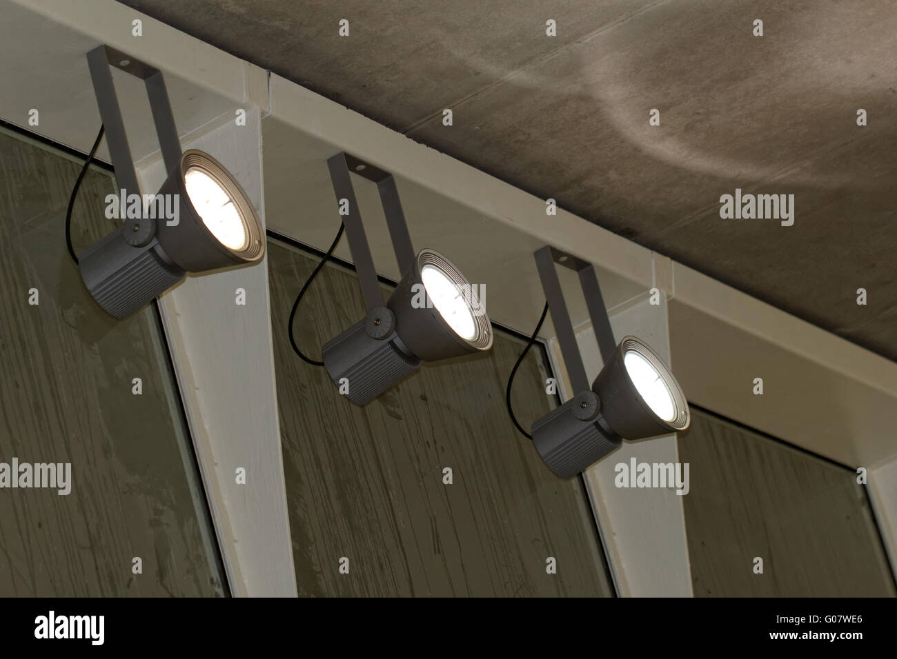 industrial lights on the wall inside a building Stock Photo - Alamy