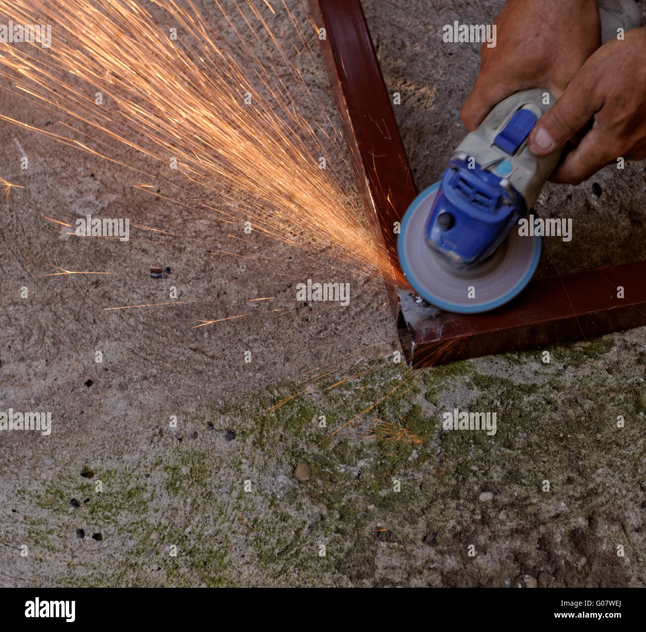 Metal buffing with hand grinder. Sparks while grinding iron Stock Photo ...