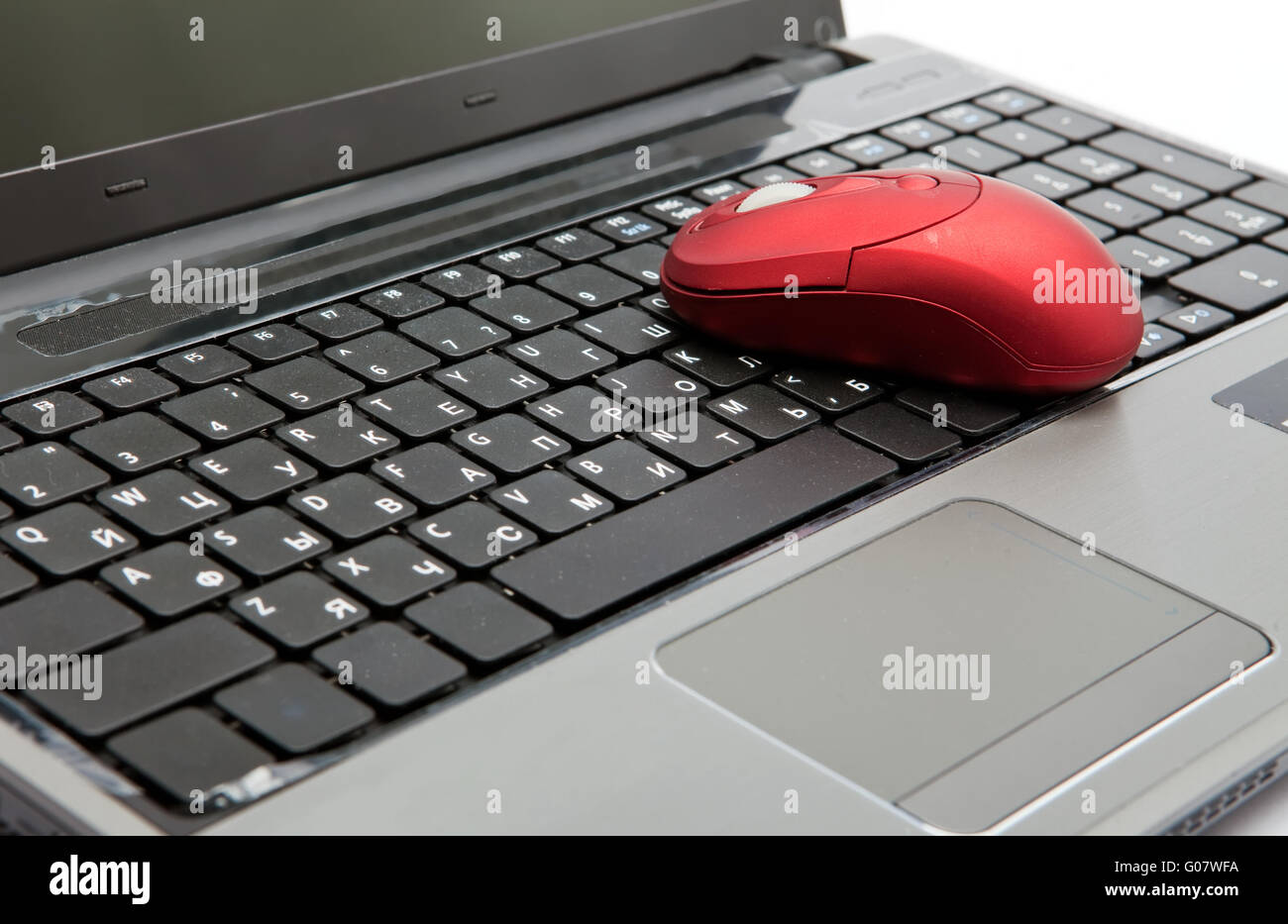 The red computer mouse on the black keyboard Stock Photo - Alamy