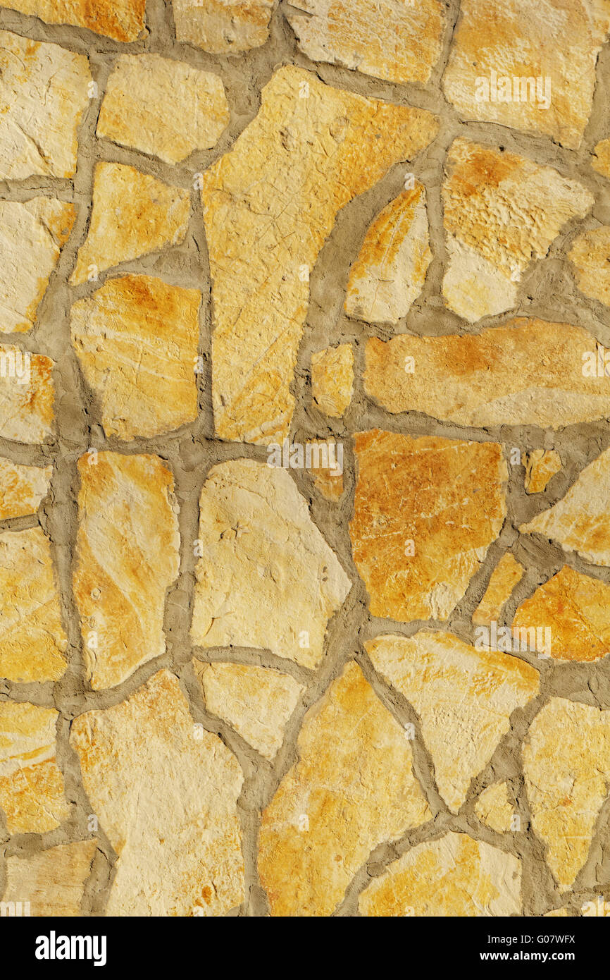 Background of a large stone wall texture (yellow Stock Photo - Alamy