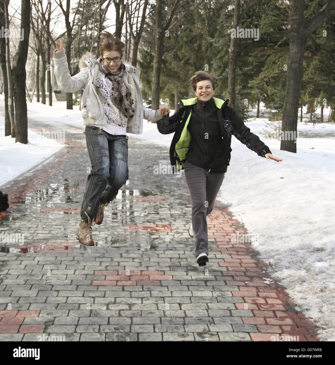 Happy mother and the daughter run on a path Stock Photo - Alamy