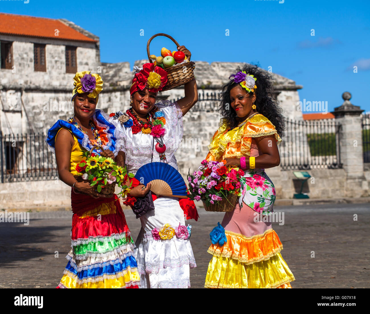 Caribbean Cuban women with flowers and fruit baske Stock Photo - Alamy