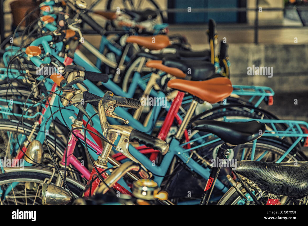 red, orange and blue bicycles parked one next to the other Stock Photo ...