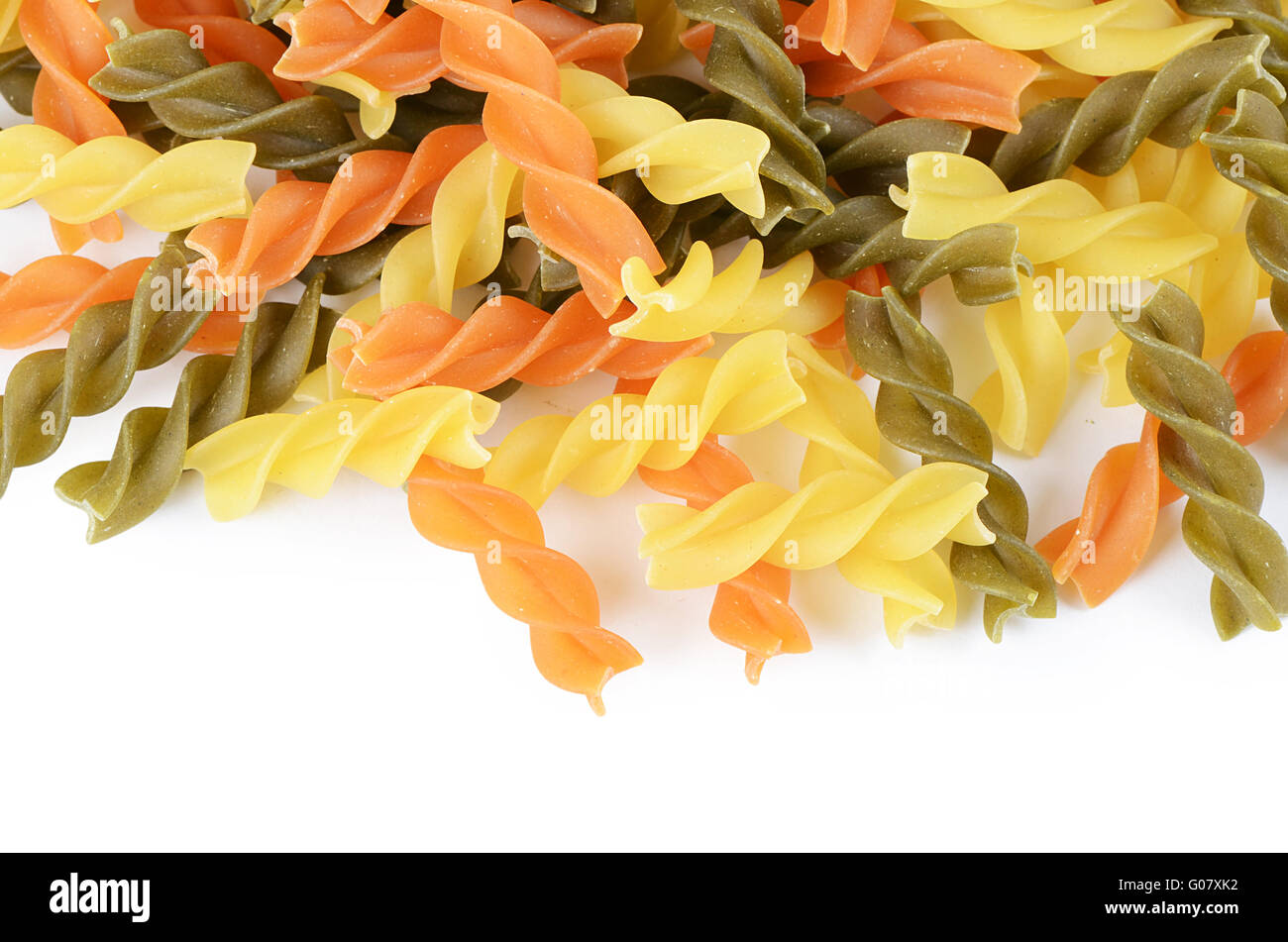 Raw colored pasta fusilli isolated on white background Stock Photo - Alamy