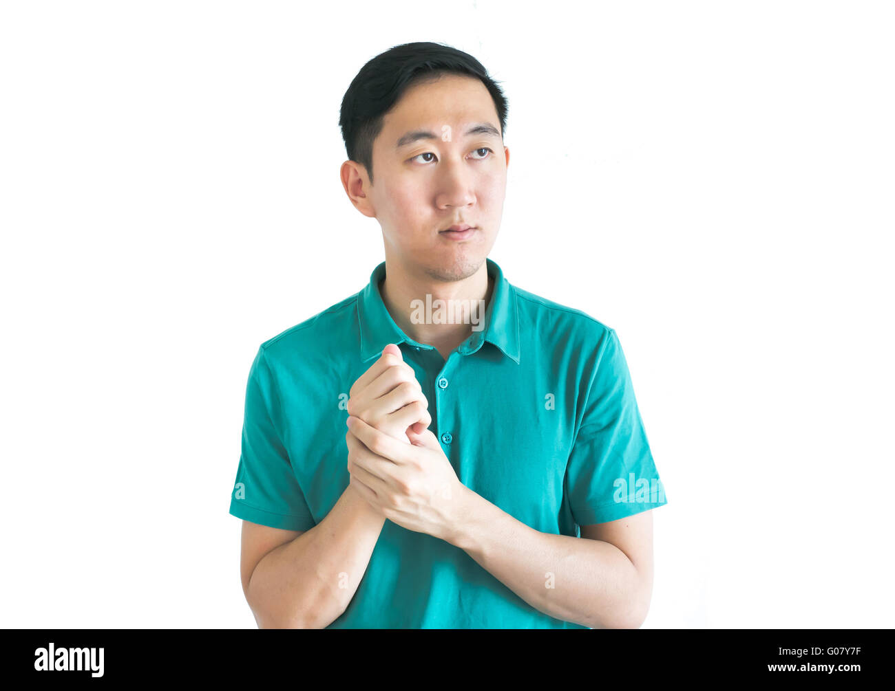Serious Asian man thinking about something on isolated white background ...