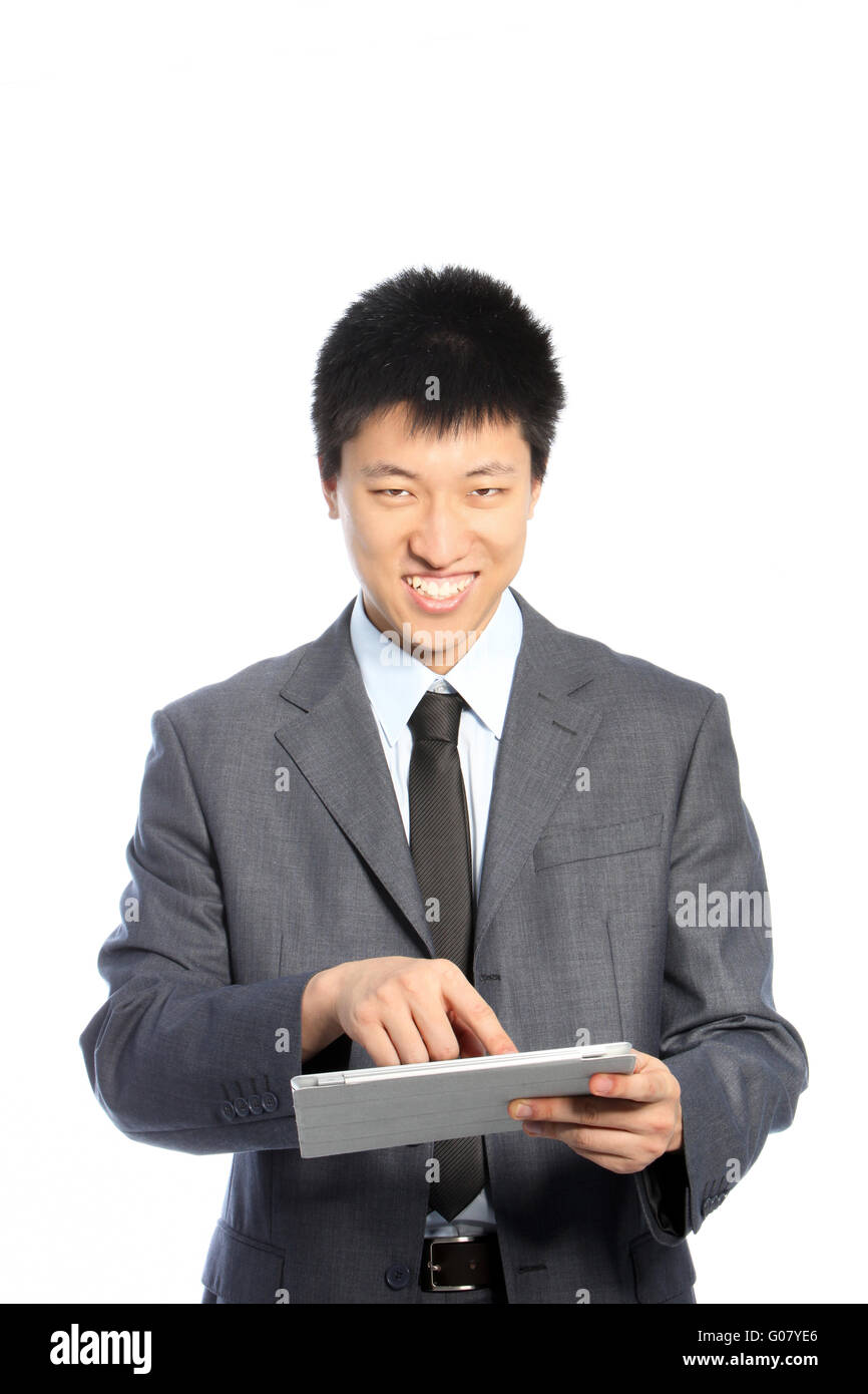 Smiling Asian young businessman using a PC tablet Stock Photo - Alamy