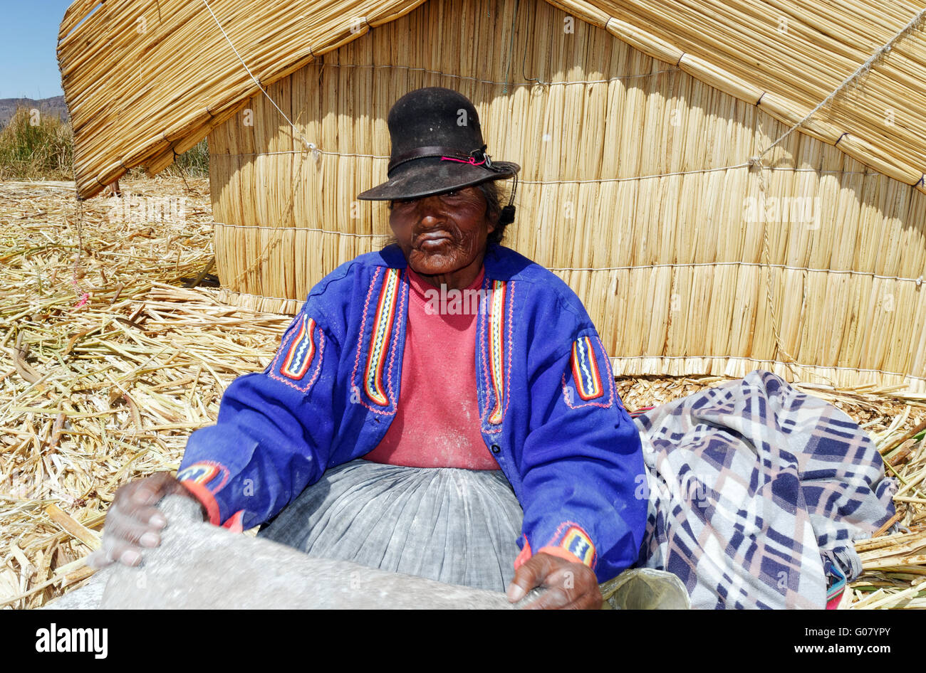 A lady showing her cloth on the floating Uros Islands, Lake Titicaca ...