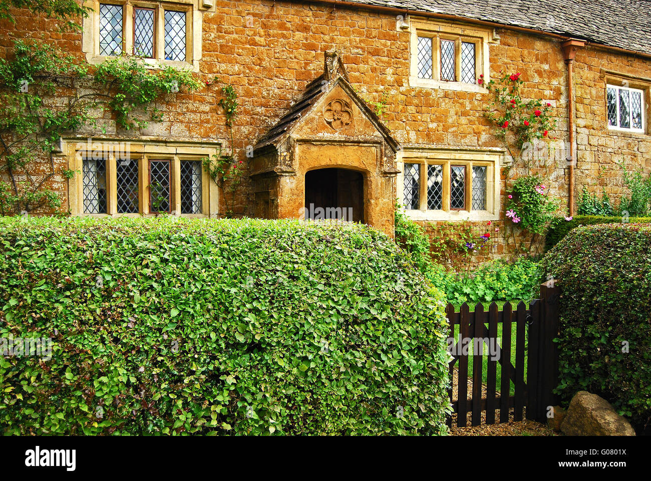 Old country stone house hedgerow wooden door Stock Photo - Alamy
