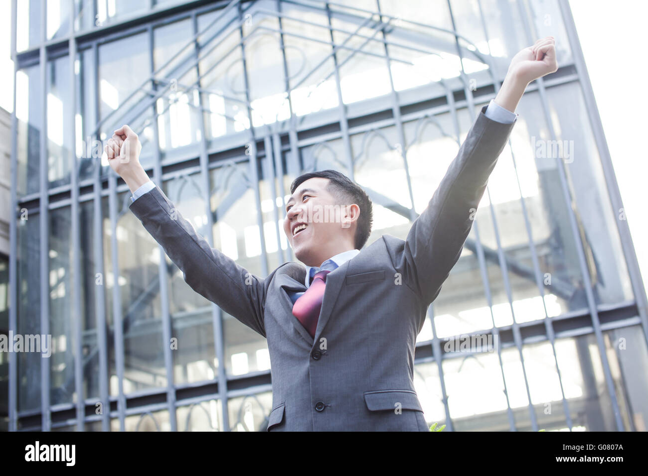 Young Business Person with raised arms screaming Stock Photo - Alamy
