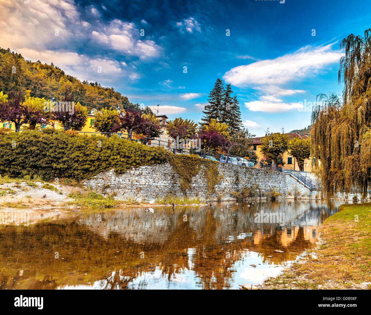 River runs thorugh medieval mountain village in Tuscany characterized ...