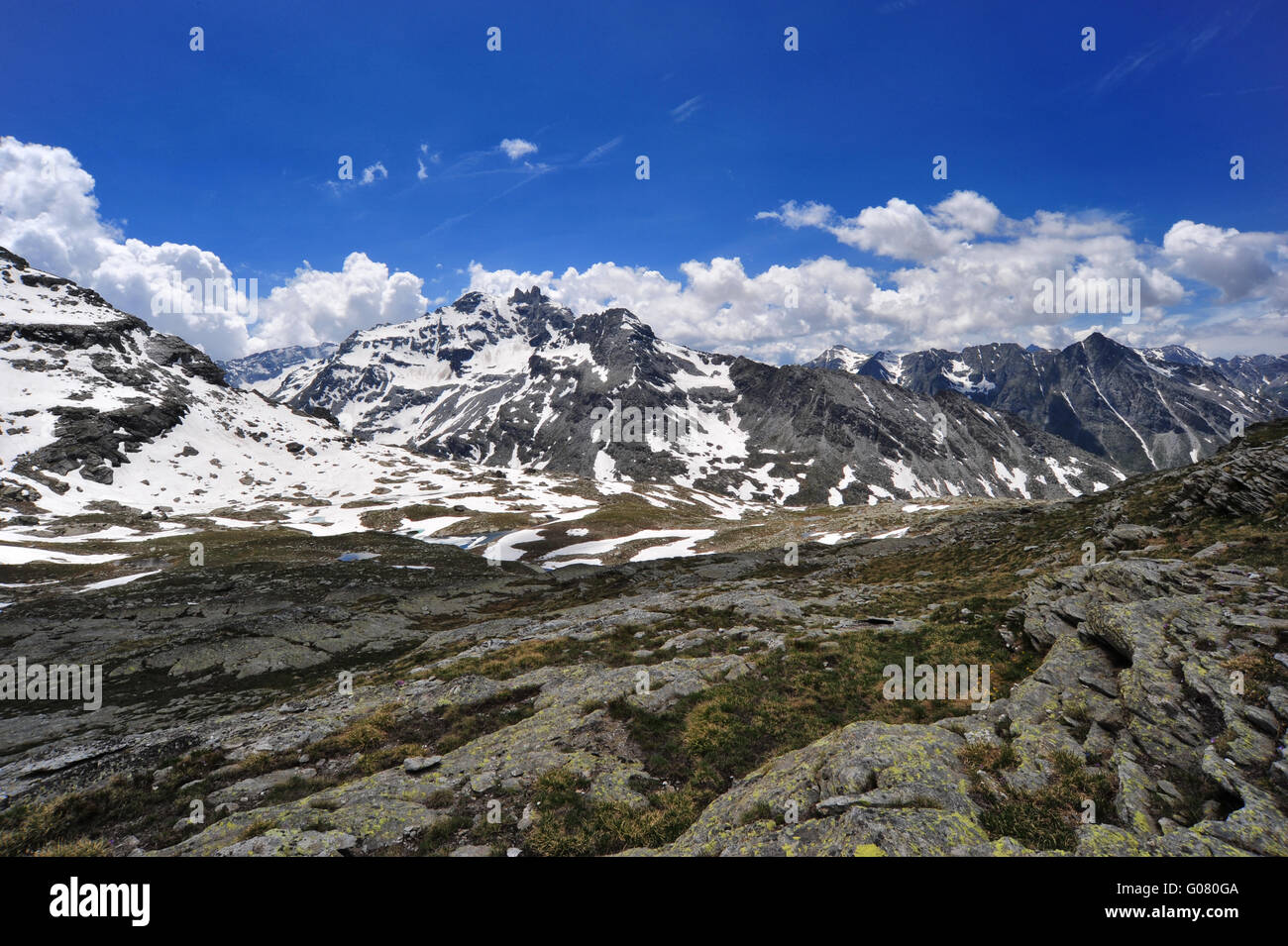 Summer in mountain with snow clouds in the sky Stock Photo - Alamy