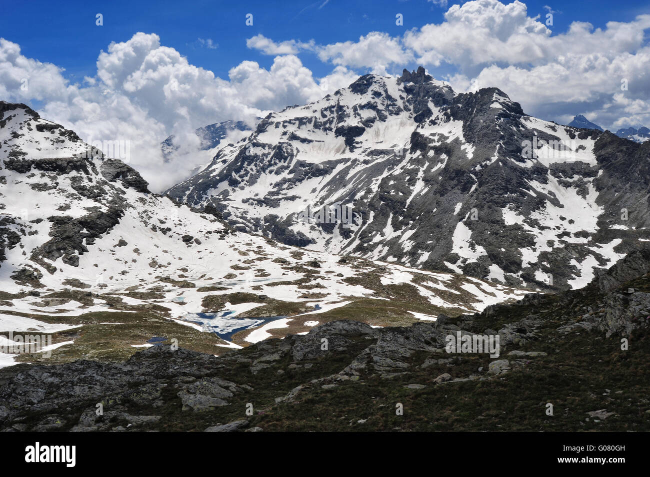 Summer in mountain with snow clouds in the sky Stock Photo - Alamy
