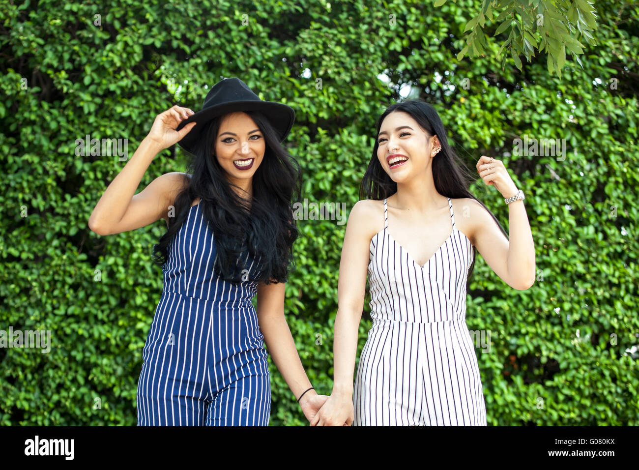 Two happy and lively female best friends having a good time together ...