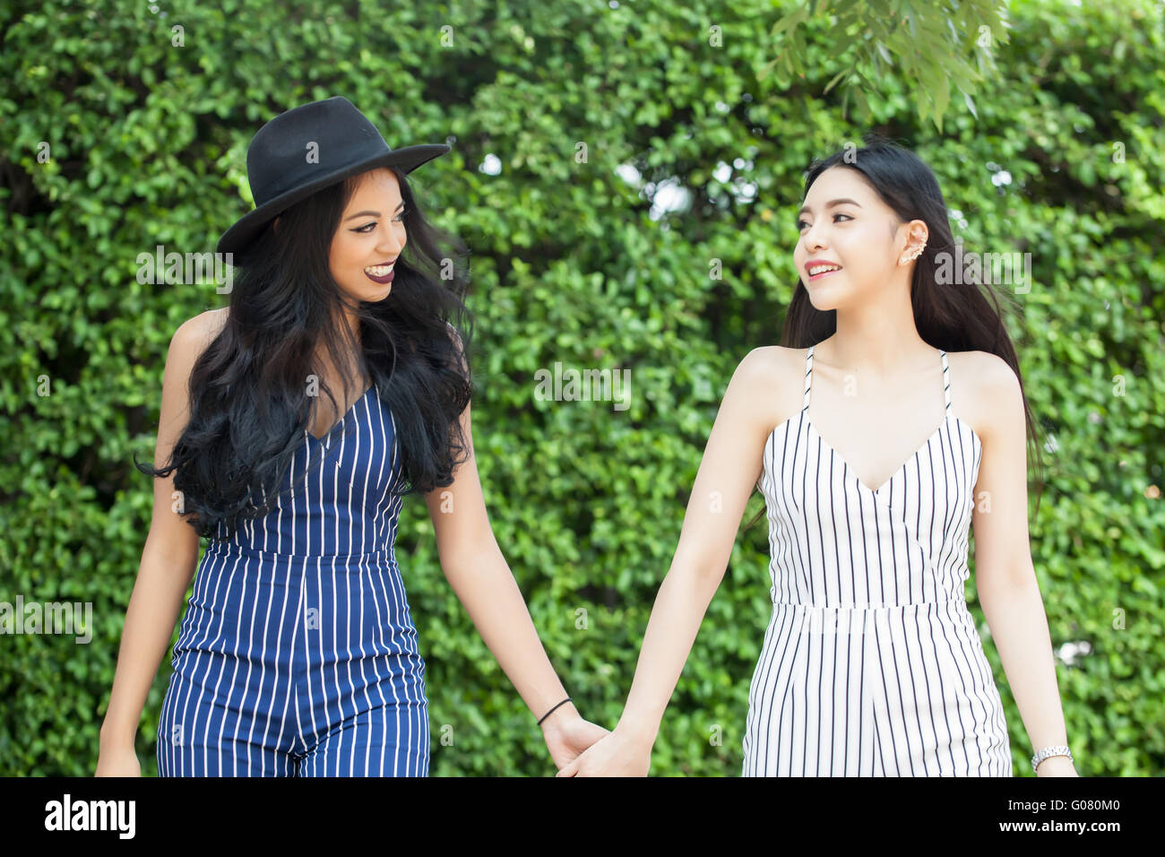 Best friends taking a walk together in outdoor park. friendship and fun ...