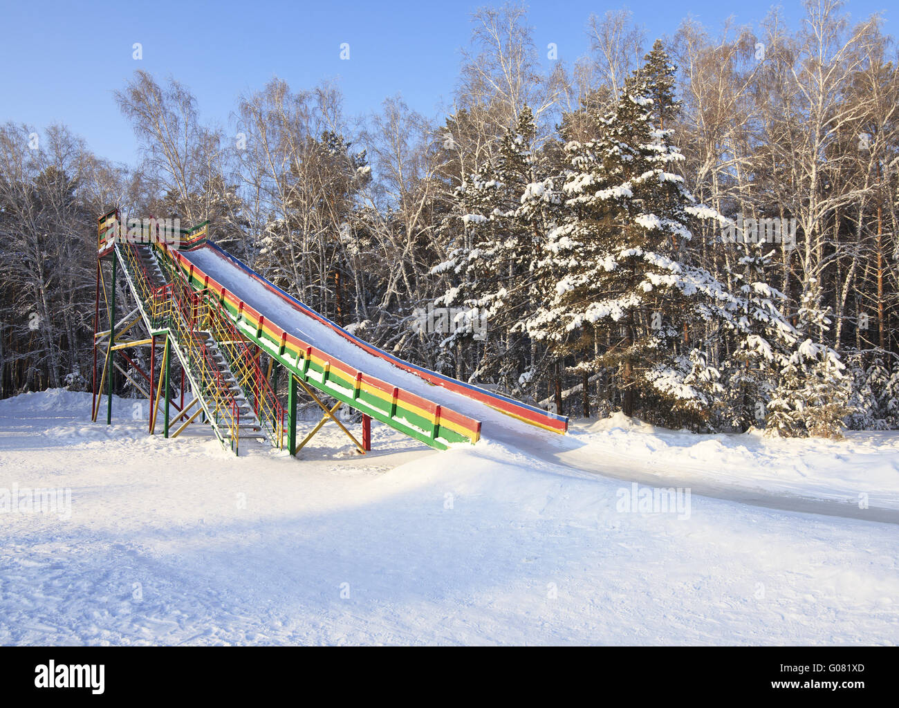 Slide covered with ice in the winter forest Stock Photo - Alamy