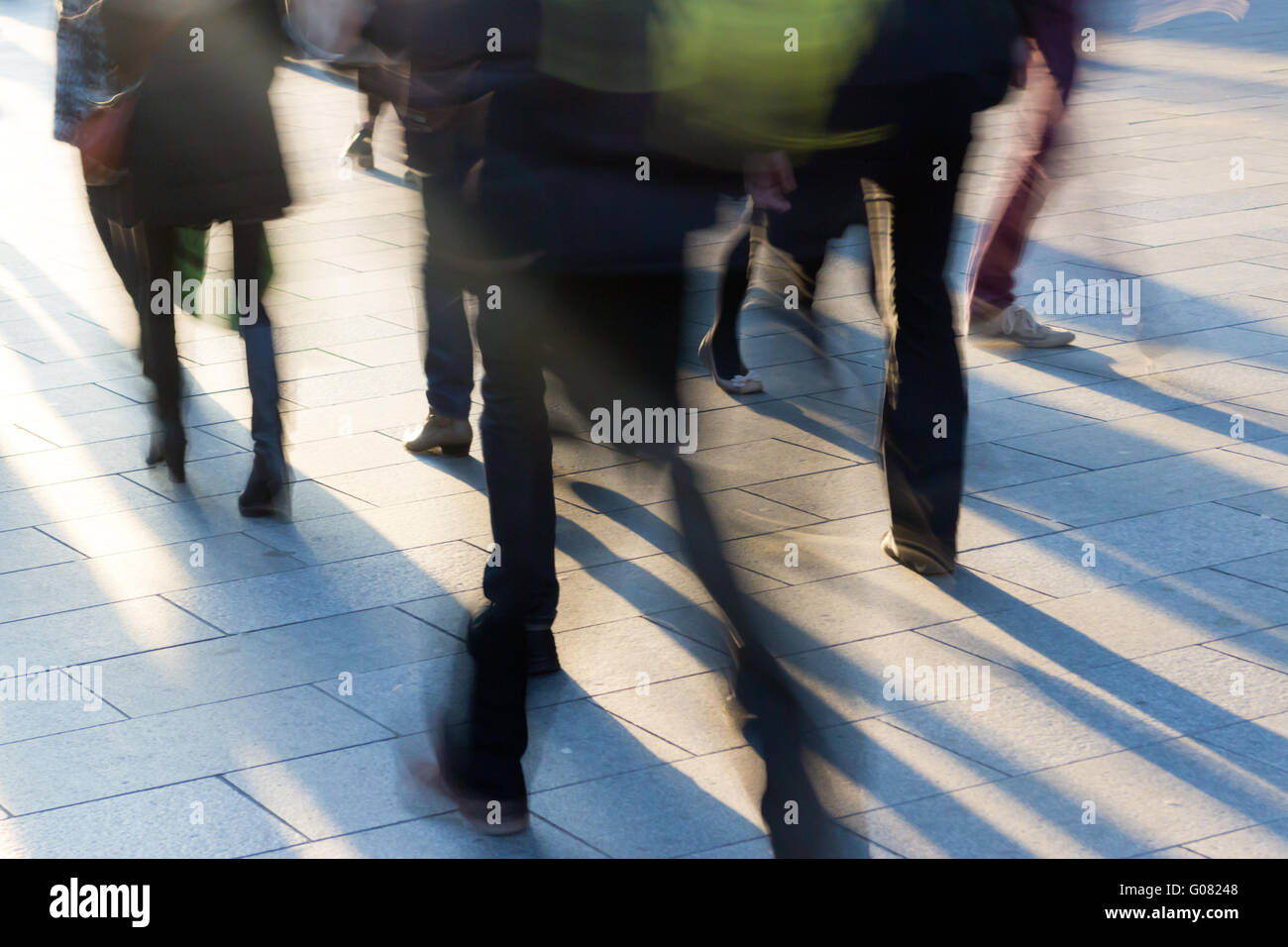 Crowd on the sidewalk at sunset with long shadows Stock Photo - Alamy