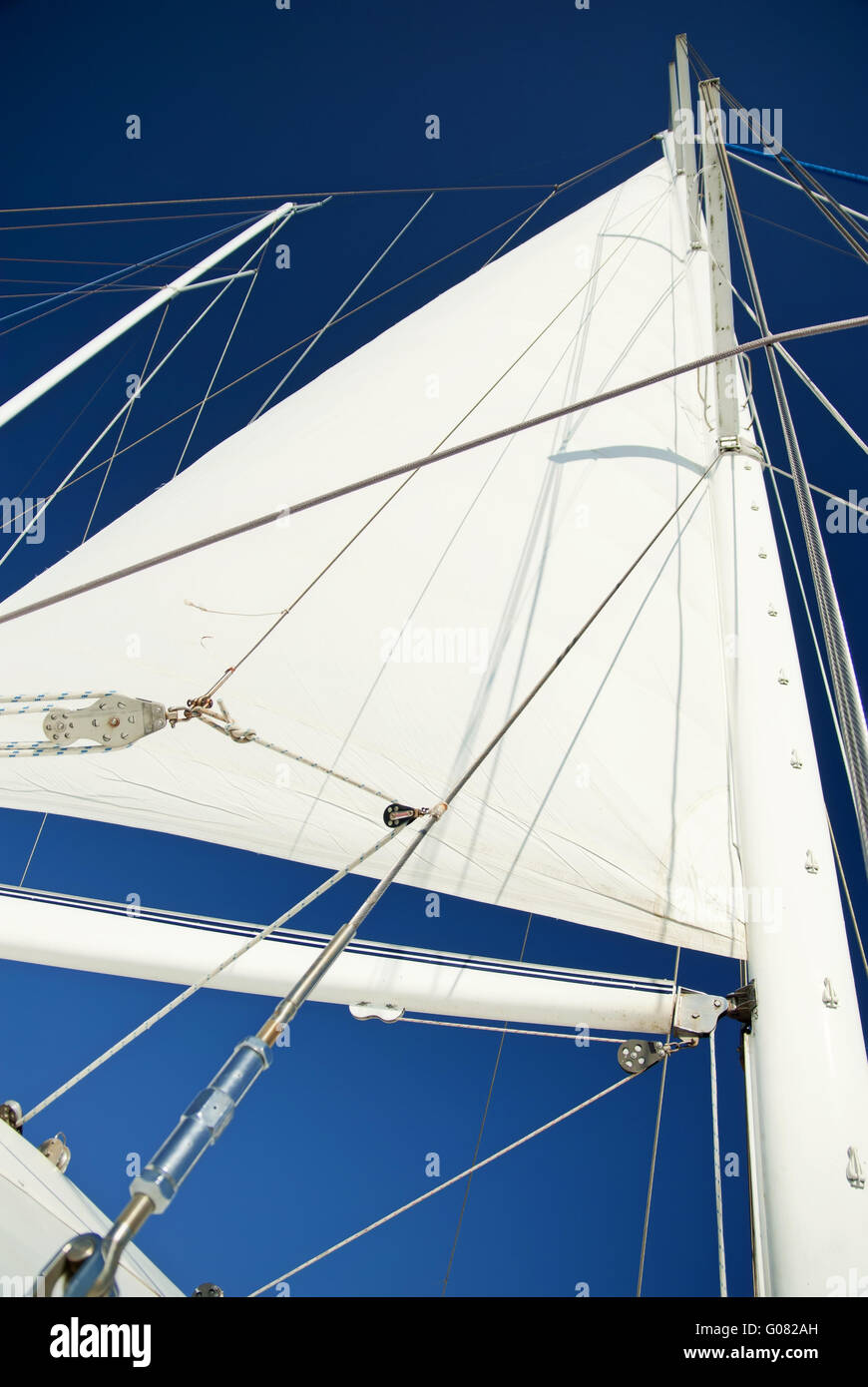 Sail of a catamaran at calm weather with blue sky Stock Photo - Alamy