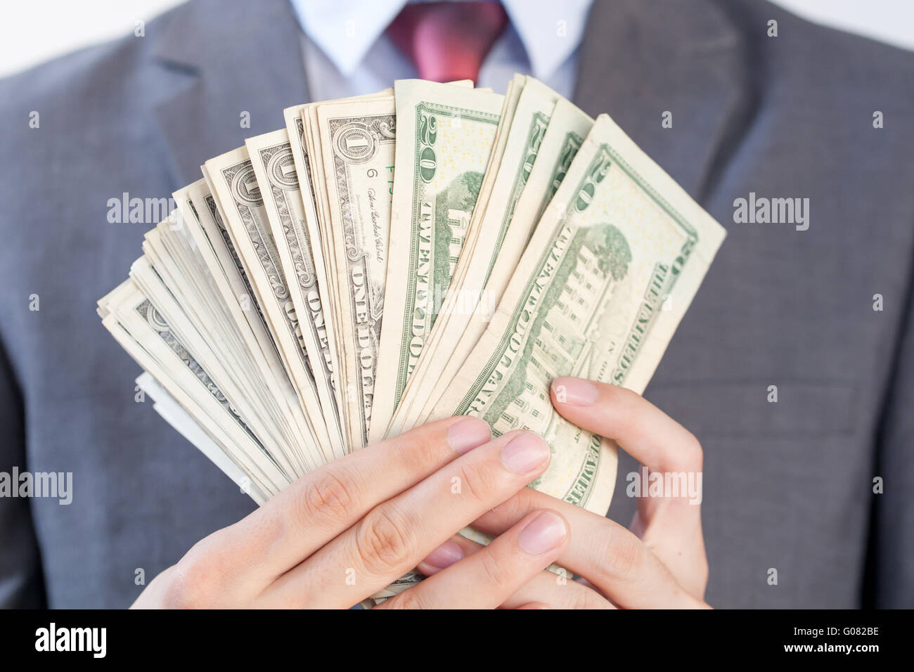 Businessman holding bank notes in white isolated background Stock Photo ...