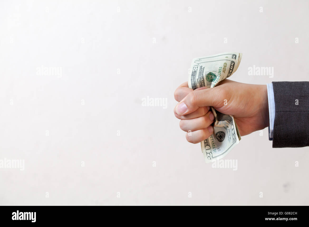 Hand squeezing money hi-res stock photography and images - Alamy