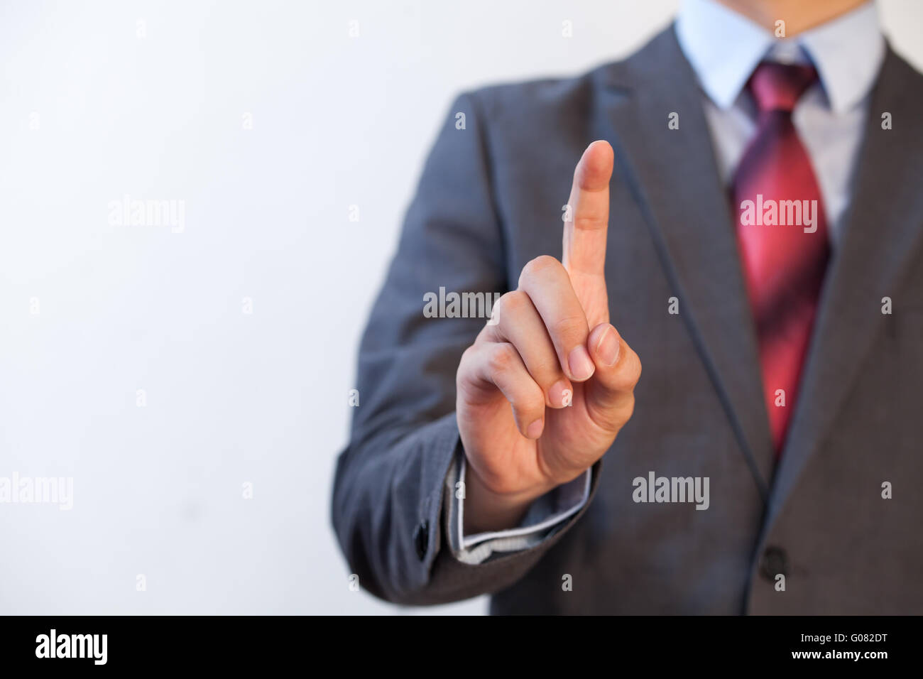 Businessman pressing in the air with one finger - Digital and ...