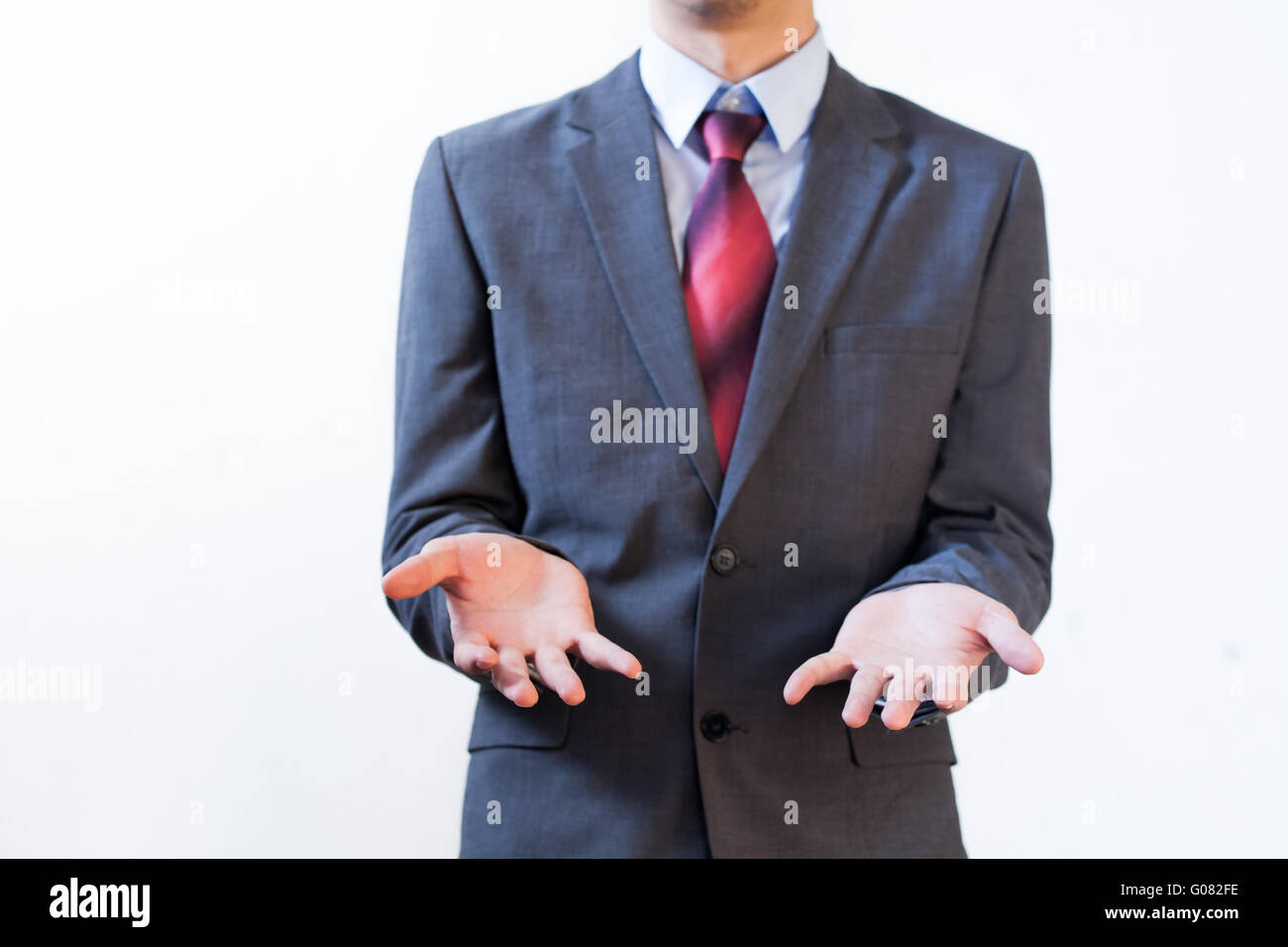 Business man in suit showing confused sign on isolated white background ...