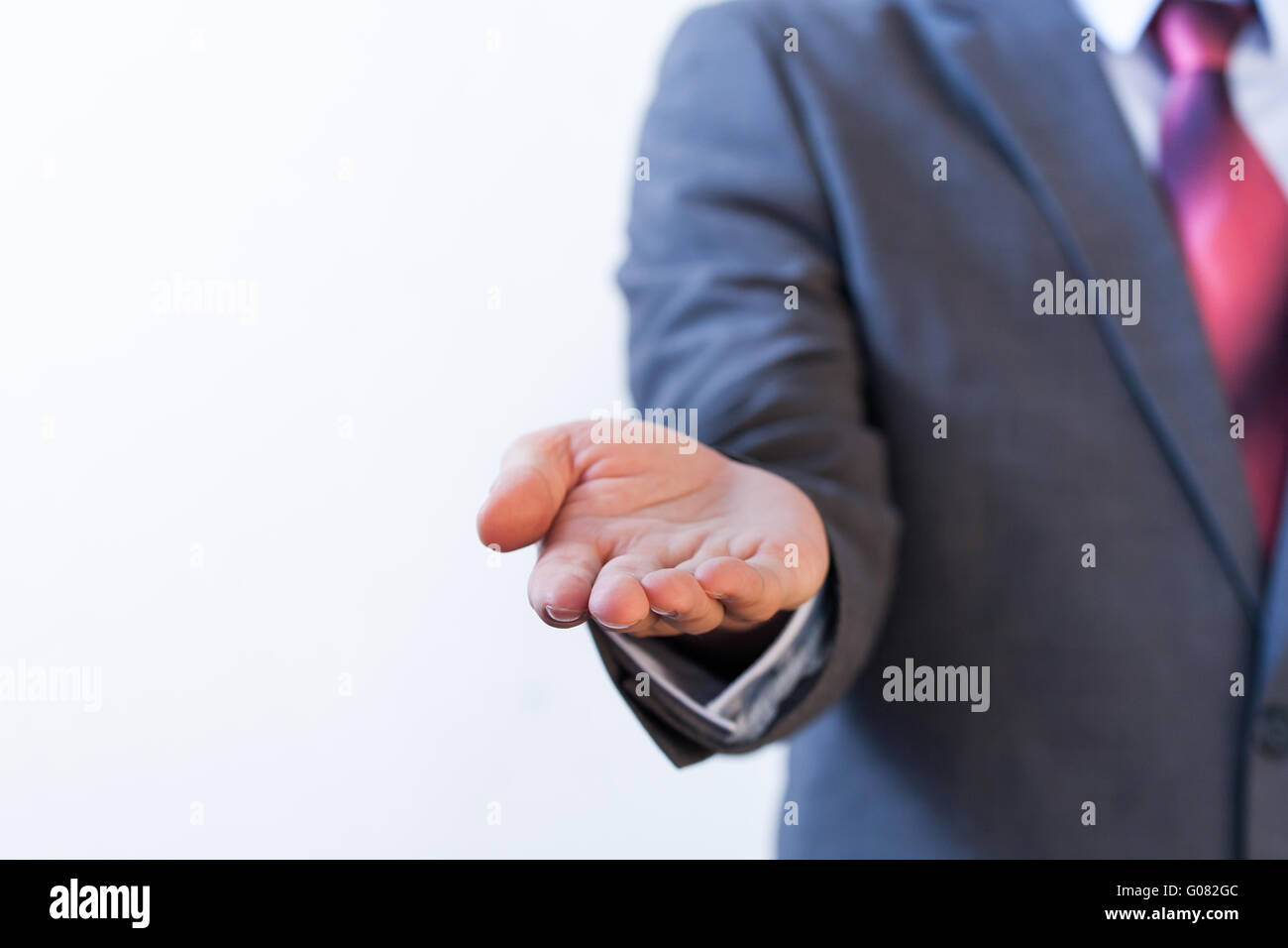 Young businessman presenting something hi-res stock photography and ...