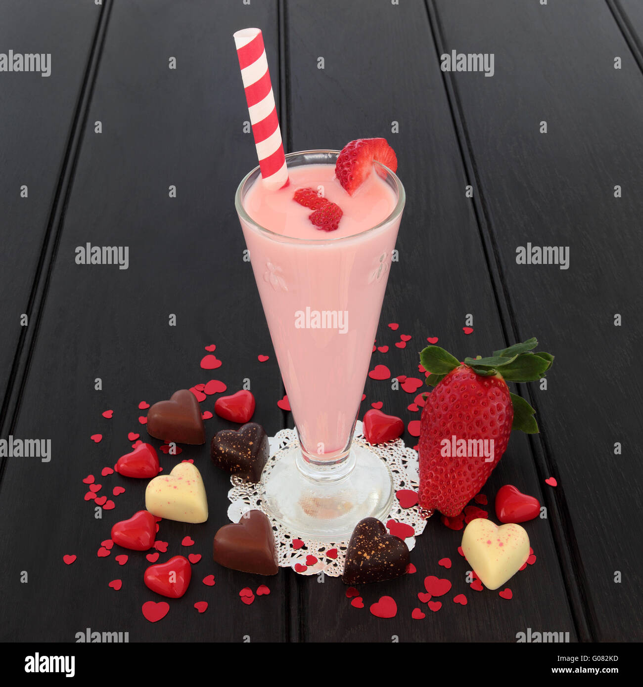 Strawberry smoothie drink with heart shaoped chocolates and decorations ...