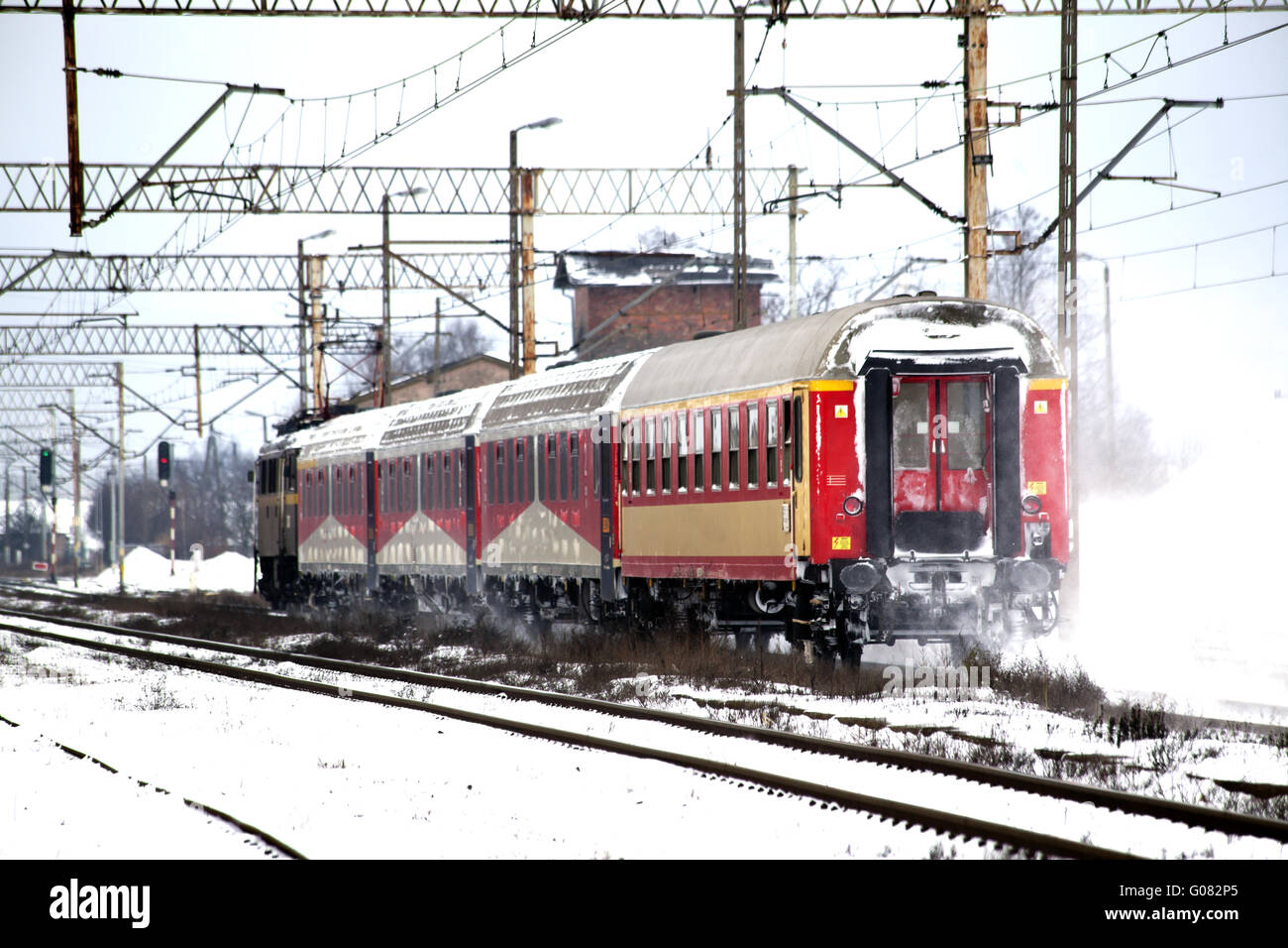 Passenger train passes the snowy line during winte Stock Photo - Alamy