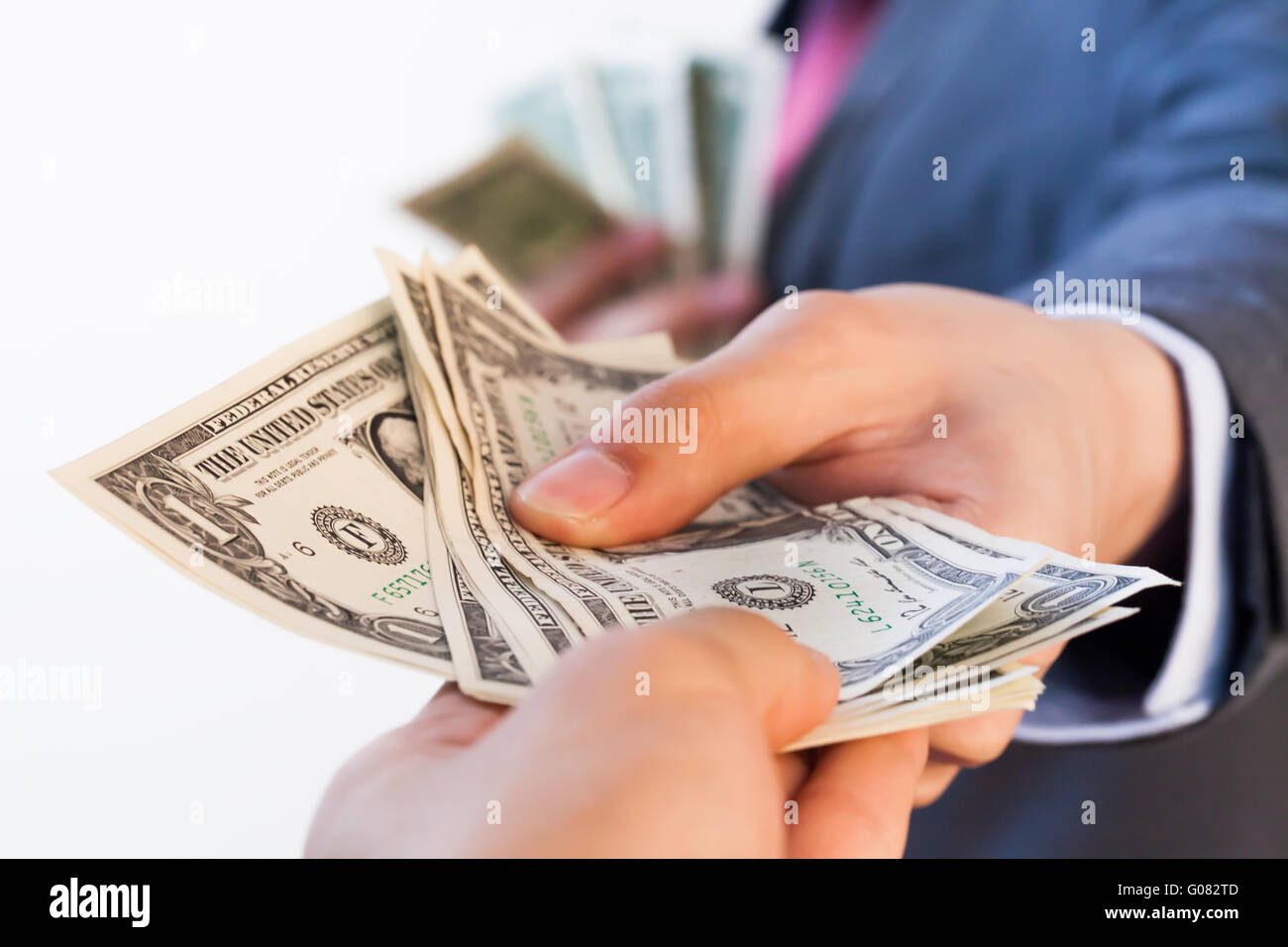 Business man giving bank notes to another person. Corruption and ...