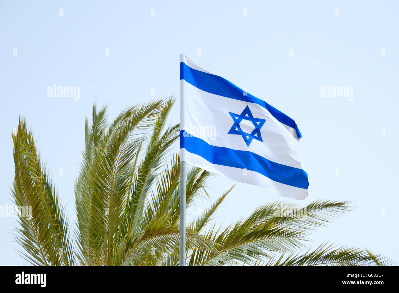Israel's flag float on the wind against a sky Stock Photo - Alamy