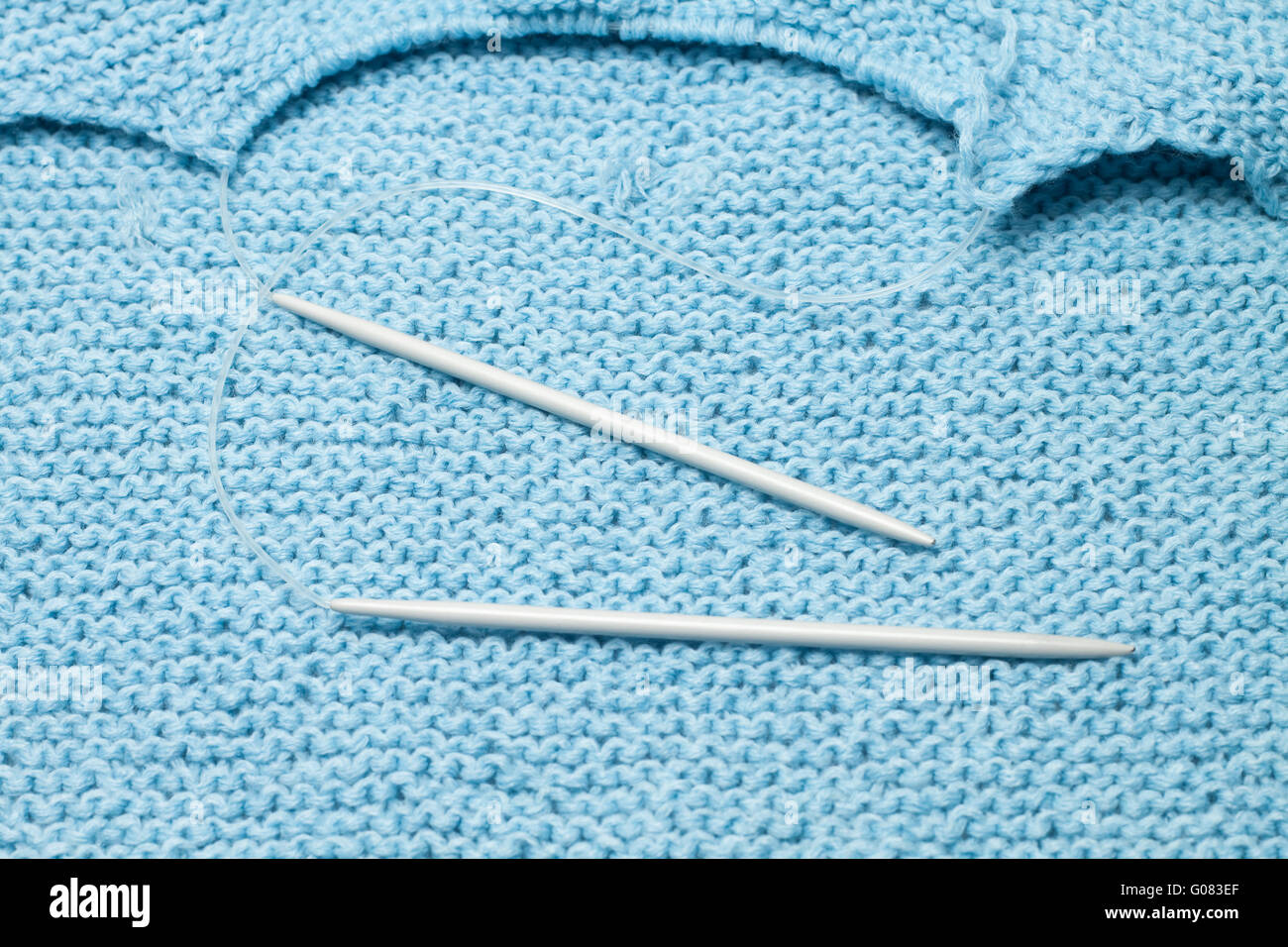 grey knitting needles on the knitted background Stock Photo - Alamy