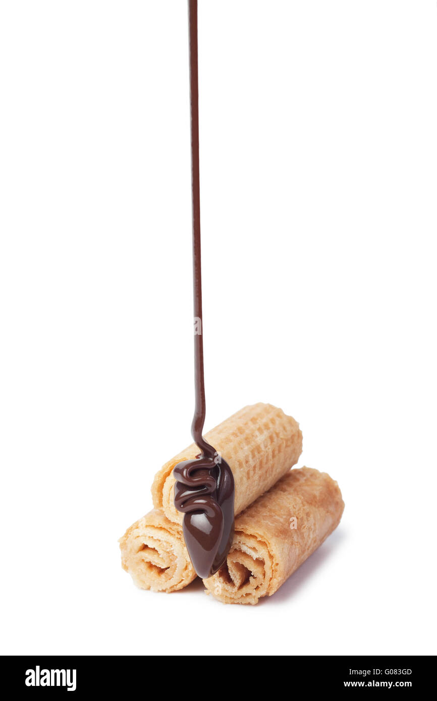 chocolate pouring onto waffle roll isolated over w Stock Photo - Alamy