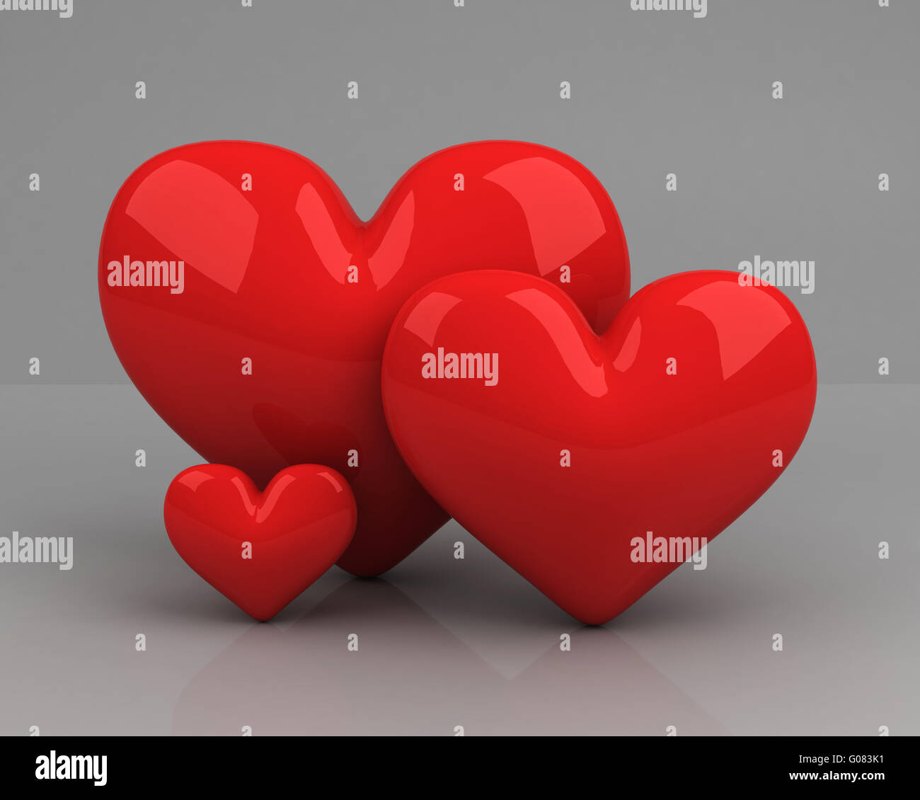 three red hearts over grey. symbol of a loving cou Stock Photo - Alamy