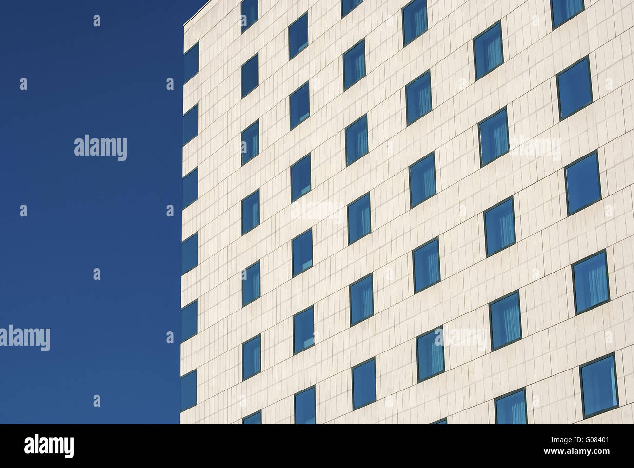 Modern public building wall, blue windows as back Stock Photo - Alamy
