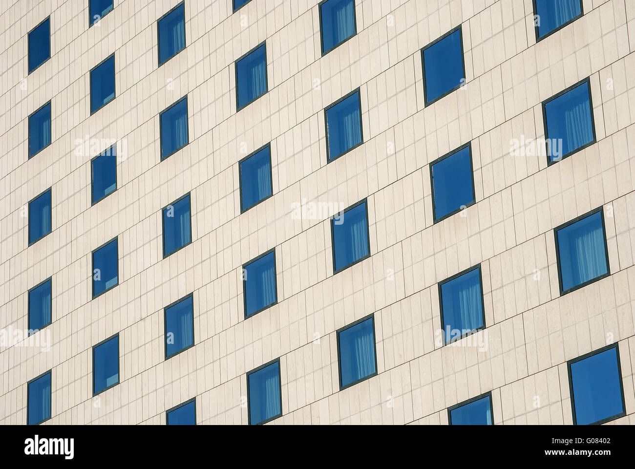 Modern public building wall, blue windows as back Stock Photo - Alamy