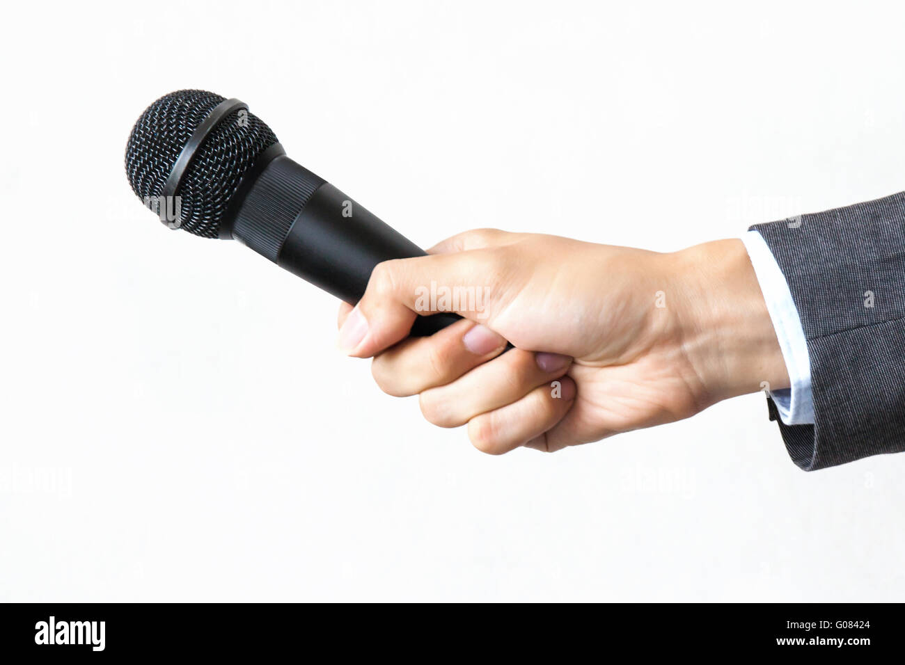Male hand with microphone on isolated white background. Business and ...