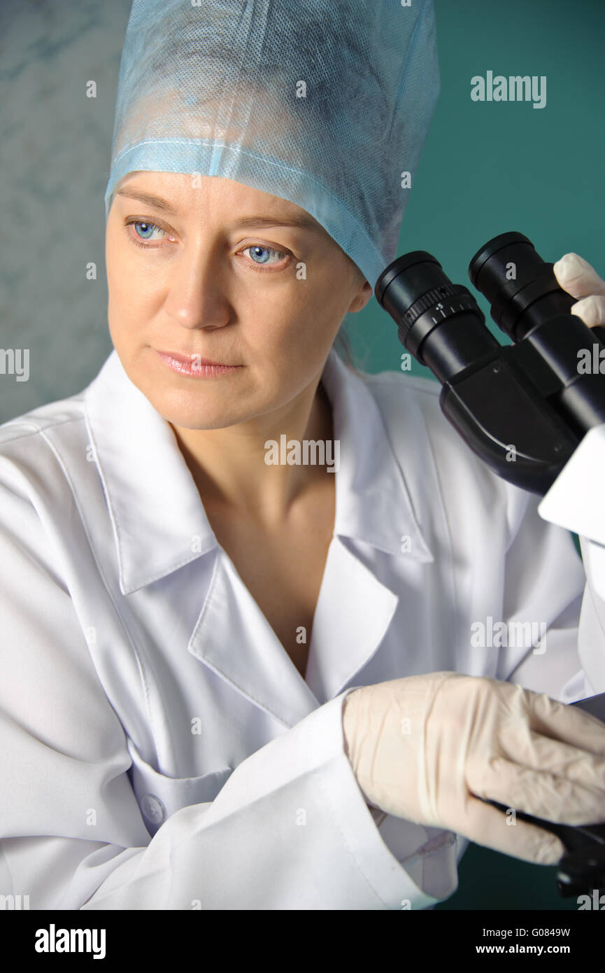 Portrait of a female doctor with a microscope Stock Photo - Alamy