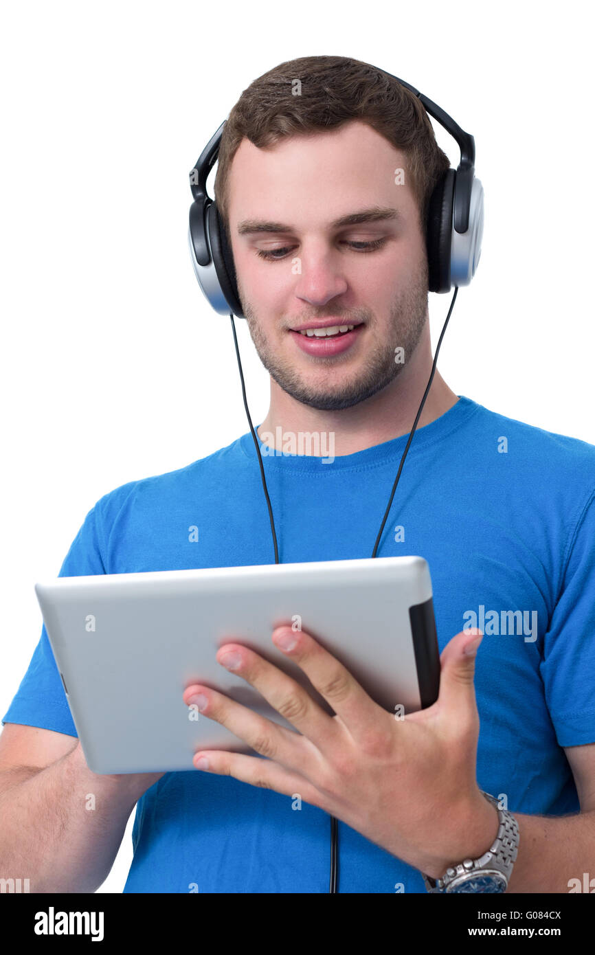 Young man with headphones working on a tablet pc Stock Photo - Alamy