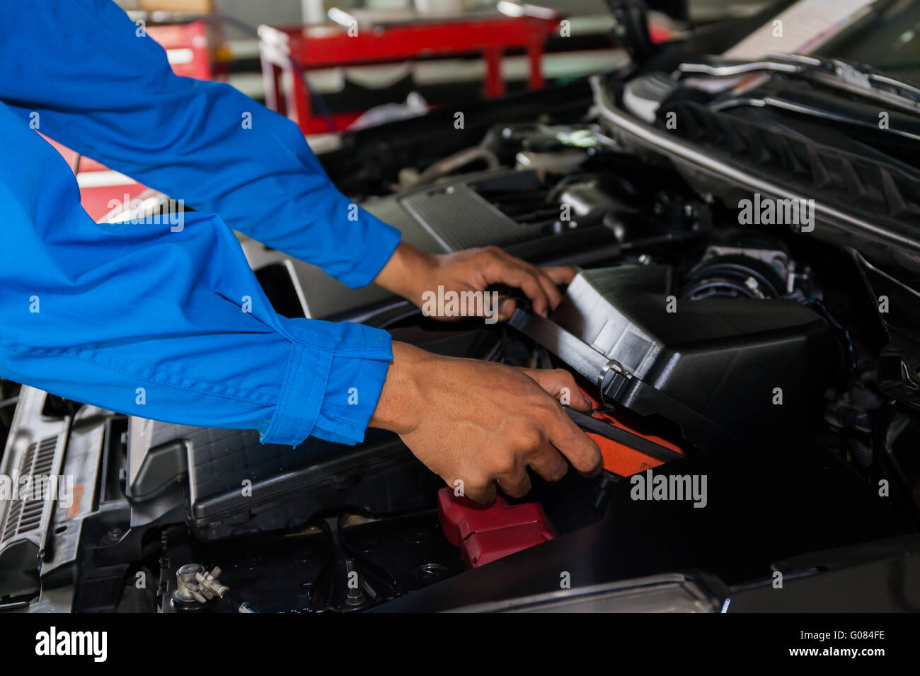 Mechanic checking and fixing a broken car in car service garage with ...