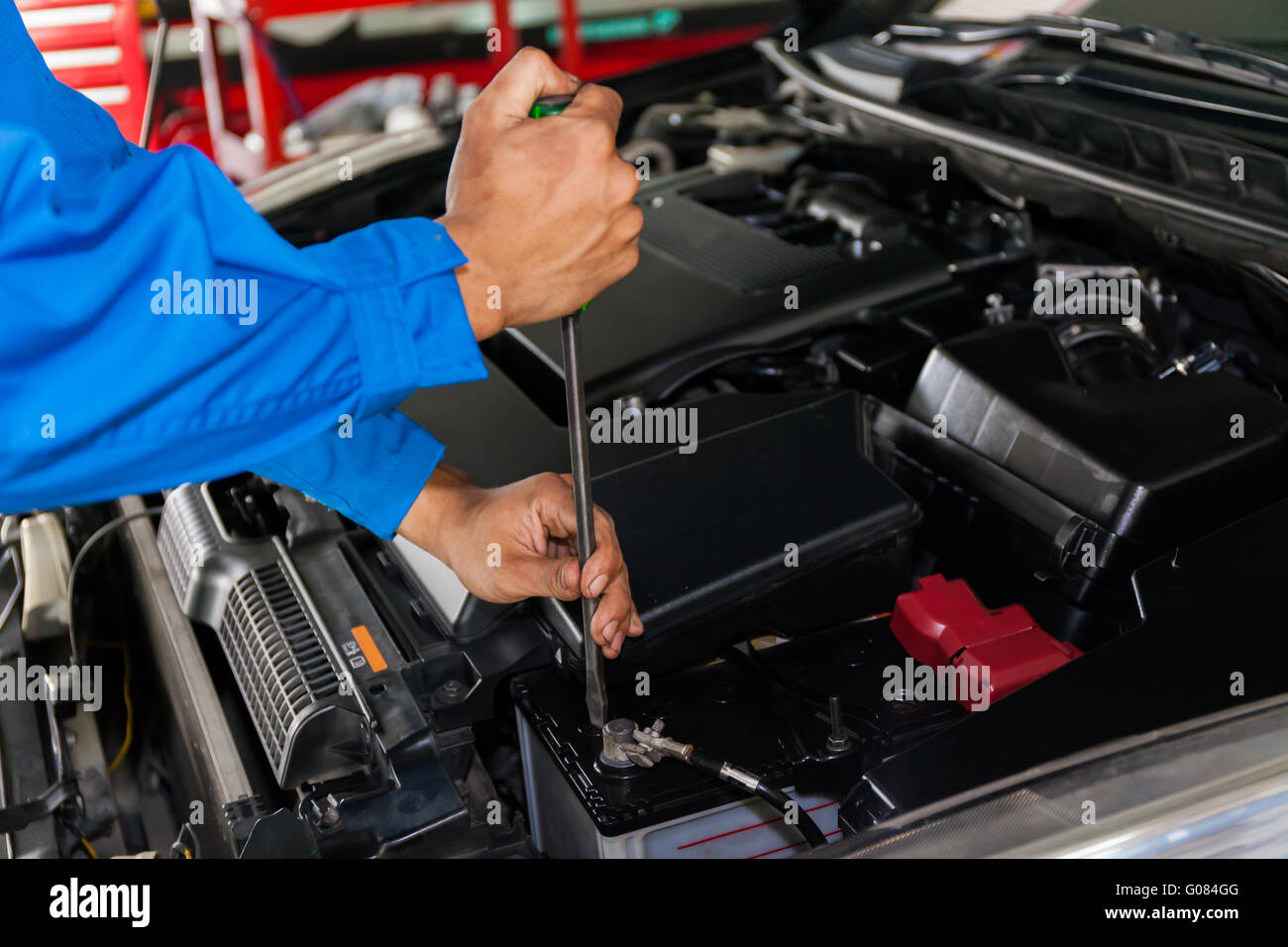 Mechanic checking and fixing a broken car in car service garage with ...