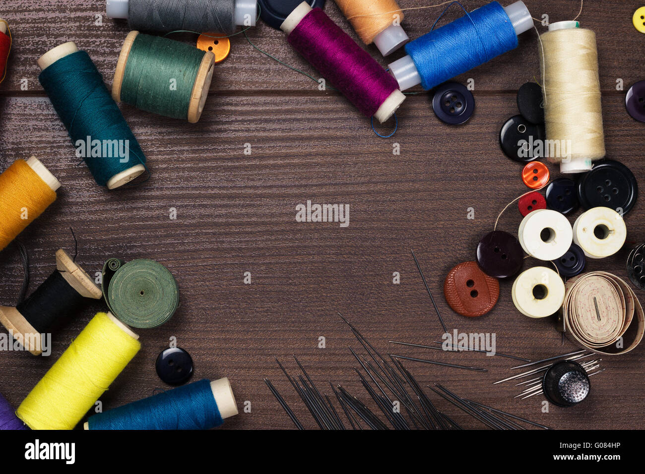threads buttons and needles on the brown wooden ta Stock Photo - Alamy