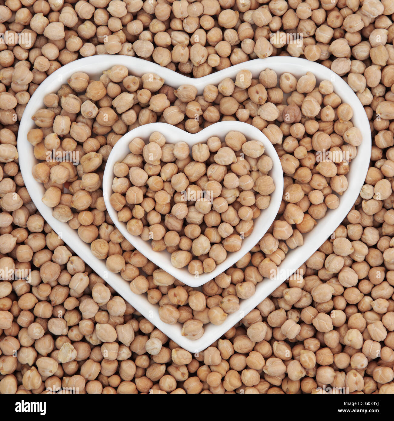 Chick pea health food in heart shaped bowls and porcelain spoon forming ...