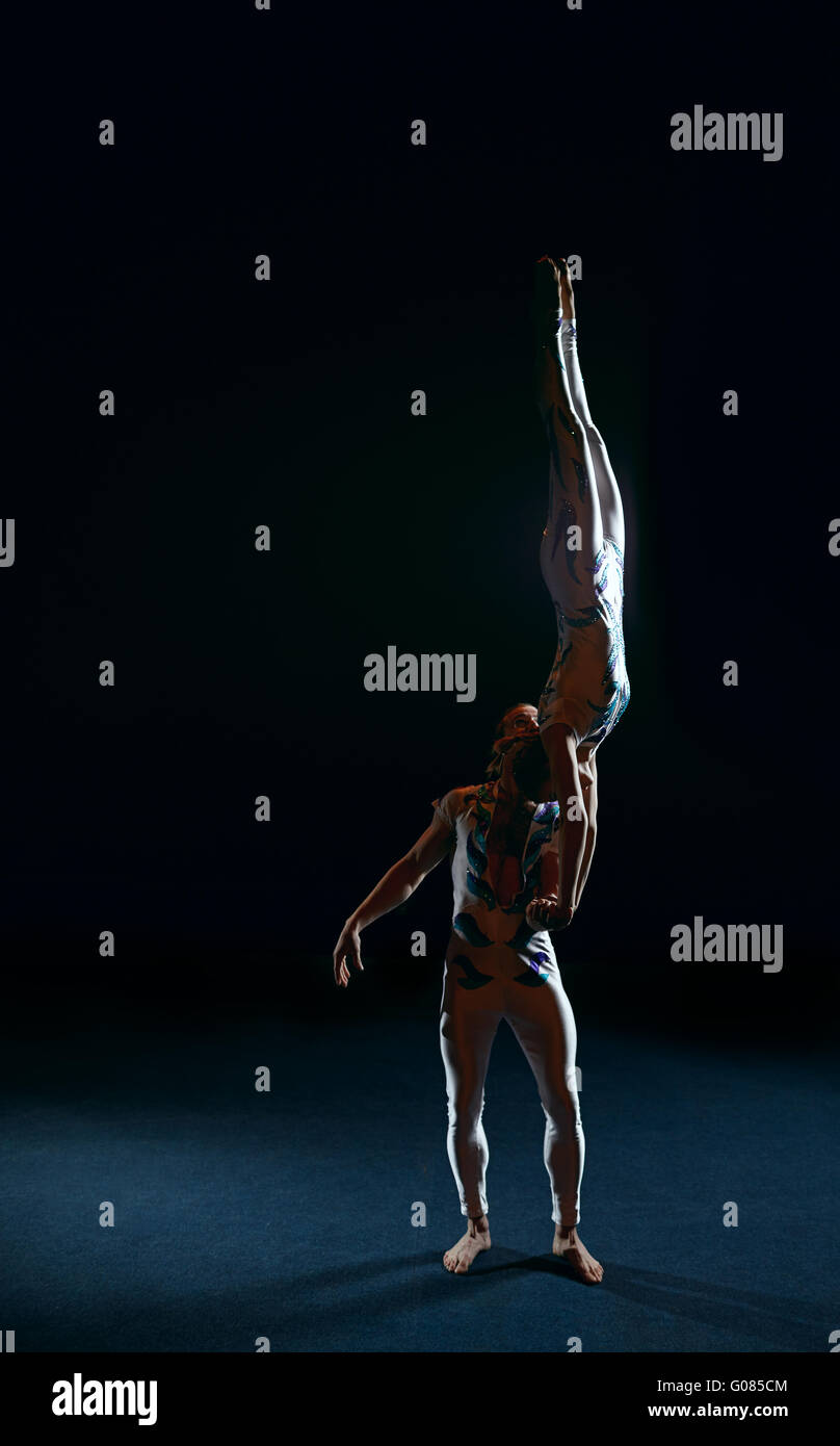 Circus artists perform different tricks. Backlight silhouettes Stock ...