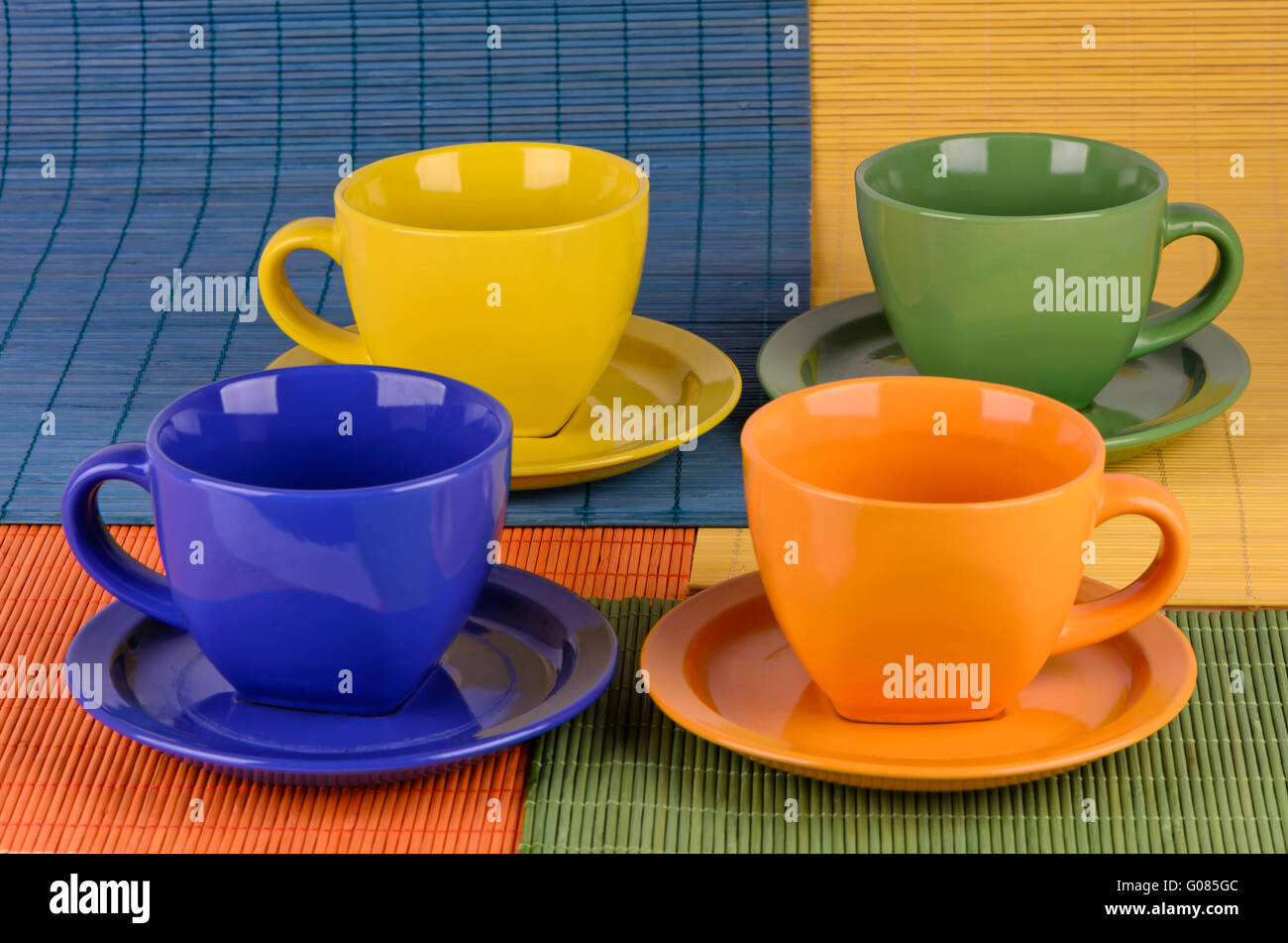 A set of colorful cups with plates Stock Photo - Alamy