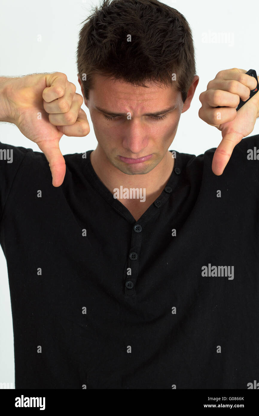 Sad man looking down in pain fully stressed and doing thumbs down Stock ...