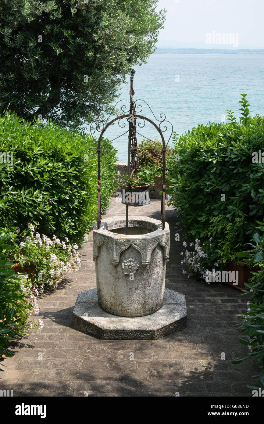 Stone well in garden near sea Stock Photo - Alamy