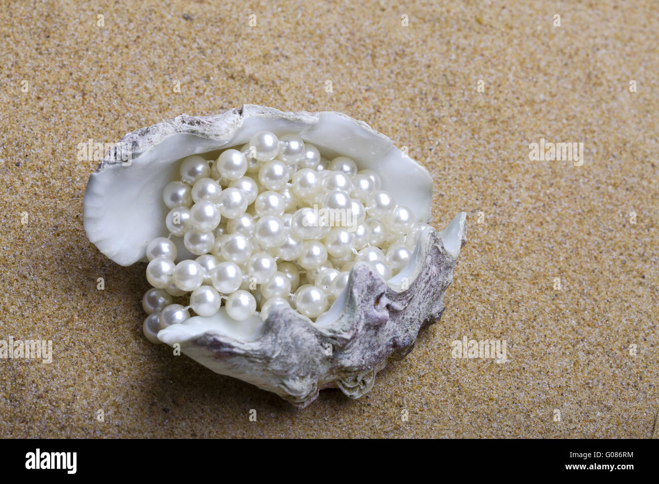 The exotic sea shell with a pearl beads lies on sa Stock Photo - Alamy