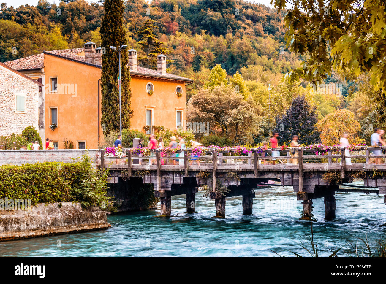 ancient buildings of a typical Italian medieval village: the river runs ...