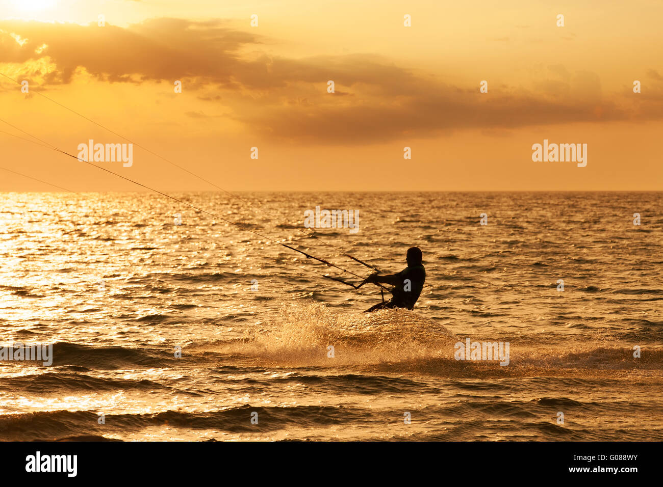 Kite surfer jumping from the water at sunset ocean Stock Photo - Alamy